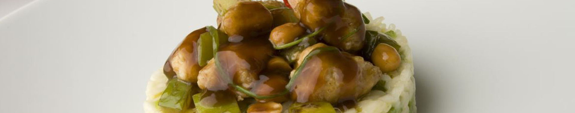 Stir-fried pork cubes with Carnaroli rice timbale and green peppers ...